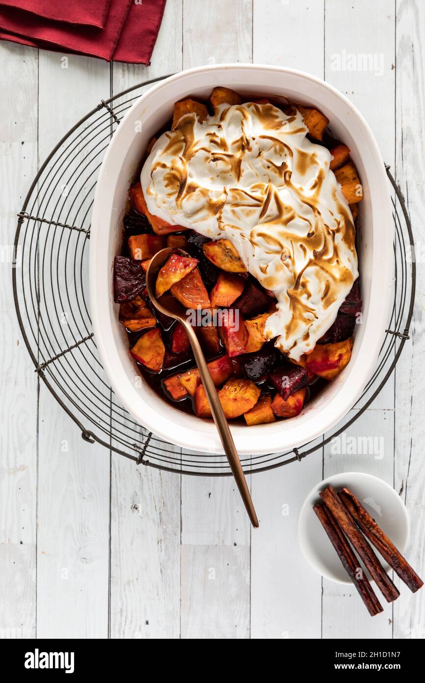 Top down view of a baked sweet potato medley topped with torched ...