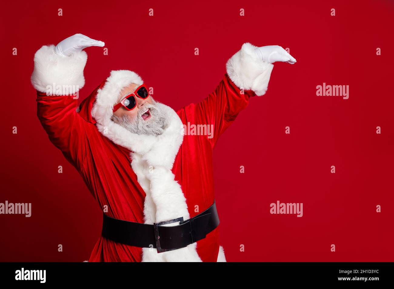 Portrait of attractive cheerful thick Santa dancing having fun fooling ...