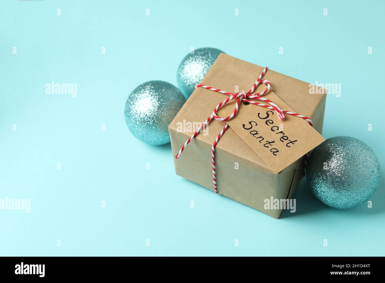 Secret Santa gift box with baubles on blue background Stock Photo - Alamy