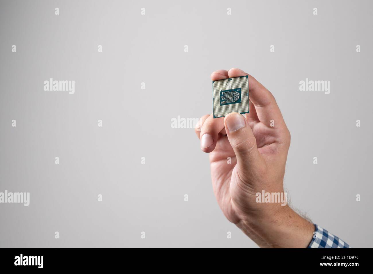 Male hand holding a processor Stock Photo - Alamy