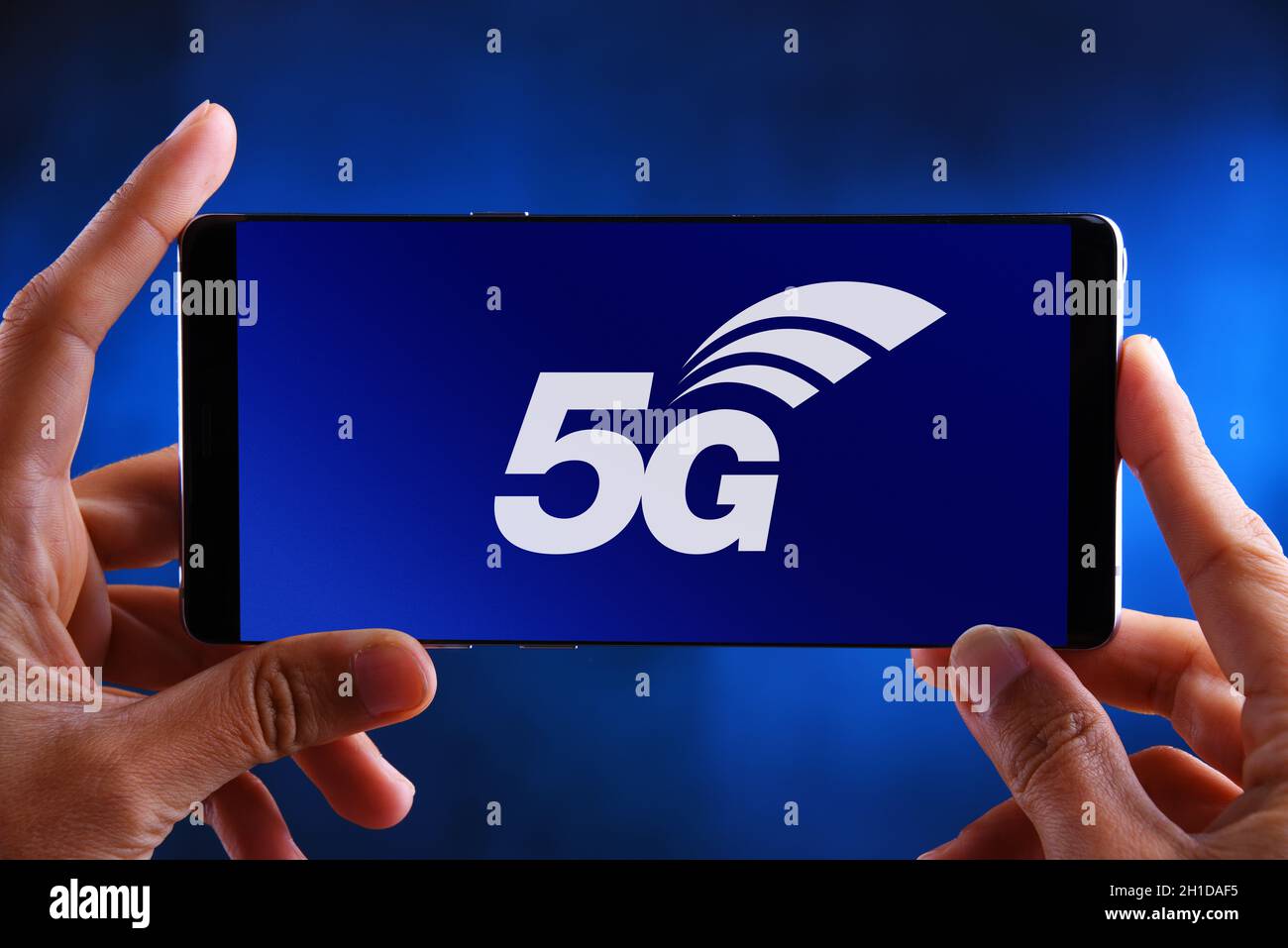 POZNAN, POL - MAR 26, 2020: Hands holding smartphone displaying logo of ...