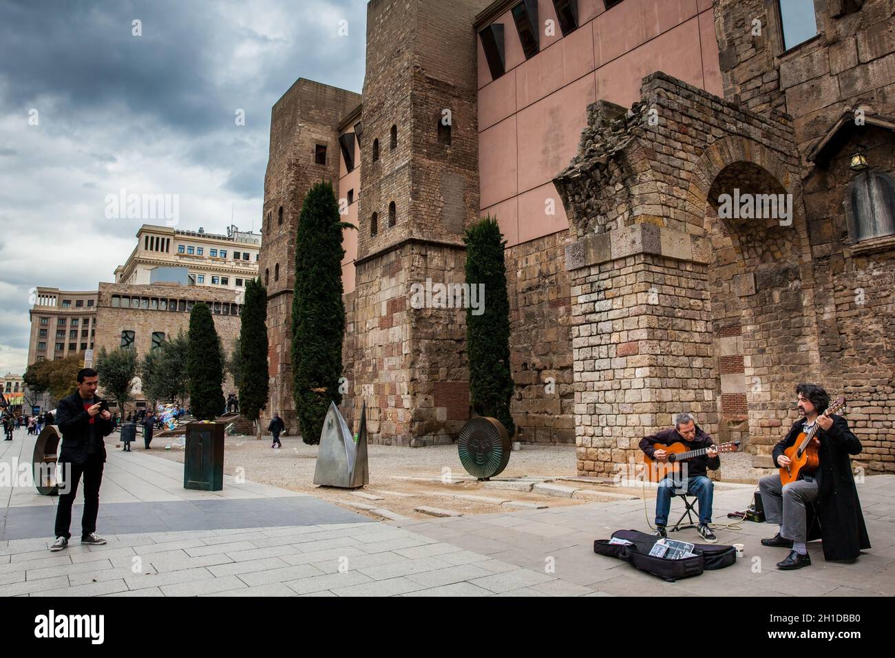 BARCELONA - MARCH, 2018: Street artists next to the Roman wall at the ...