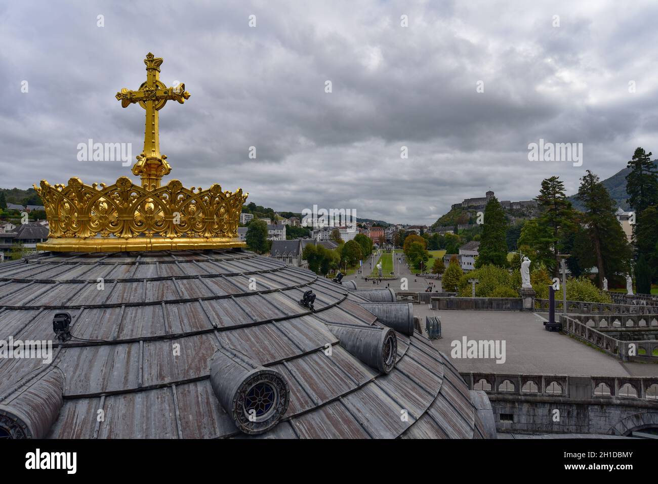 Lourdes, France - 9 Oct 2021: Gold gilded cross atop the dome of the ...