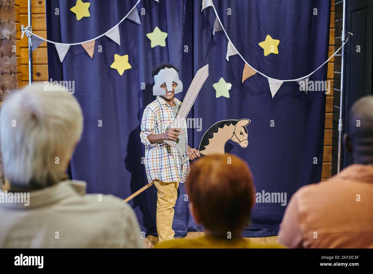 Boy in stage costume acting on the scene, he showing the performance to ...