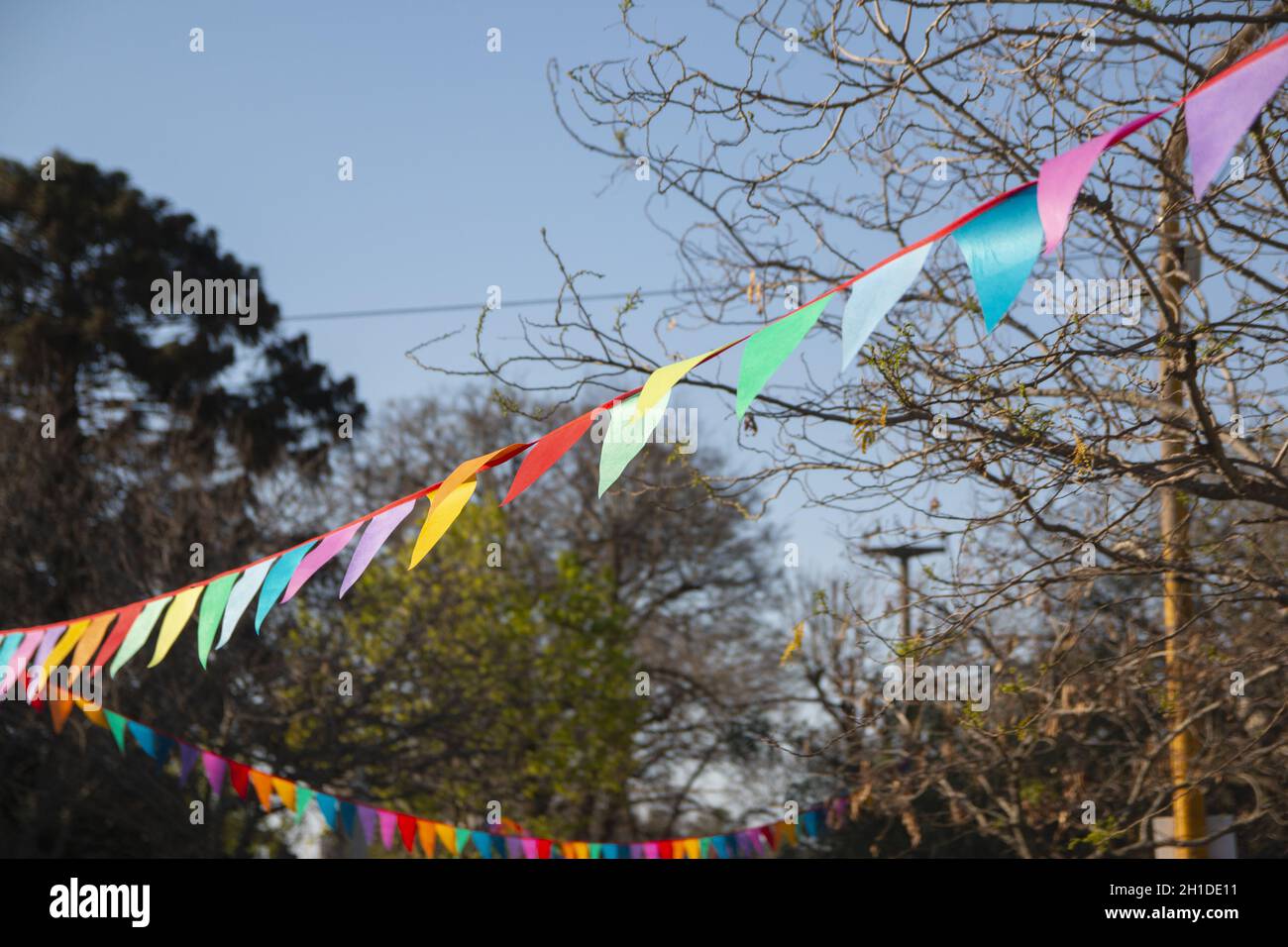 Closeup shot of colorful flags hanging on a string in the park Stock ...