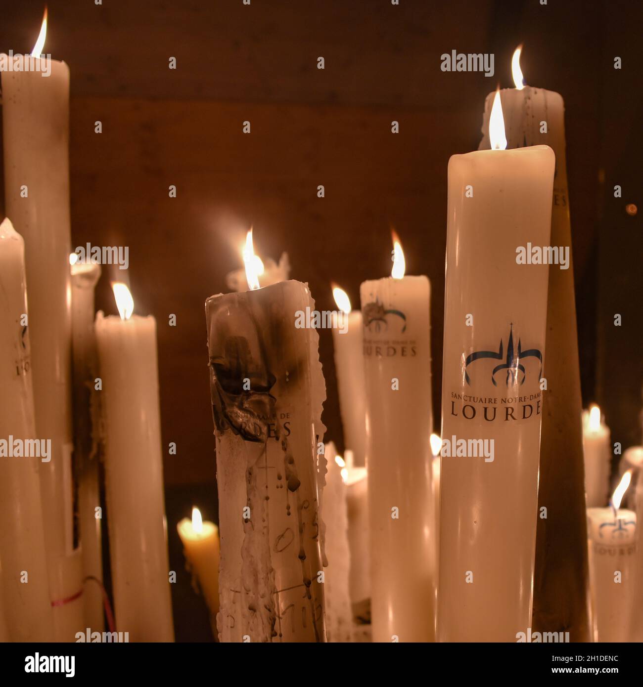 Lourdes, France - 9 Oct 2021: Candles glow at a shrine within the ...