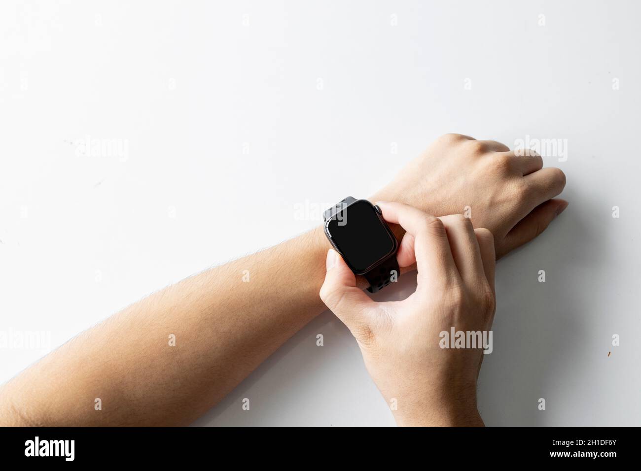 businessman wearing digital smart watch in hand touching screen to open ...