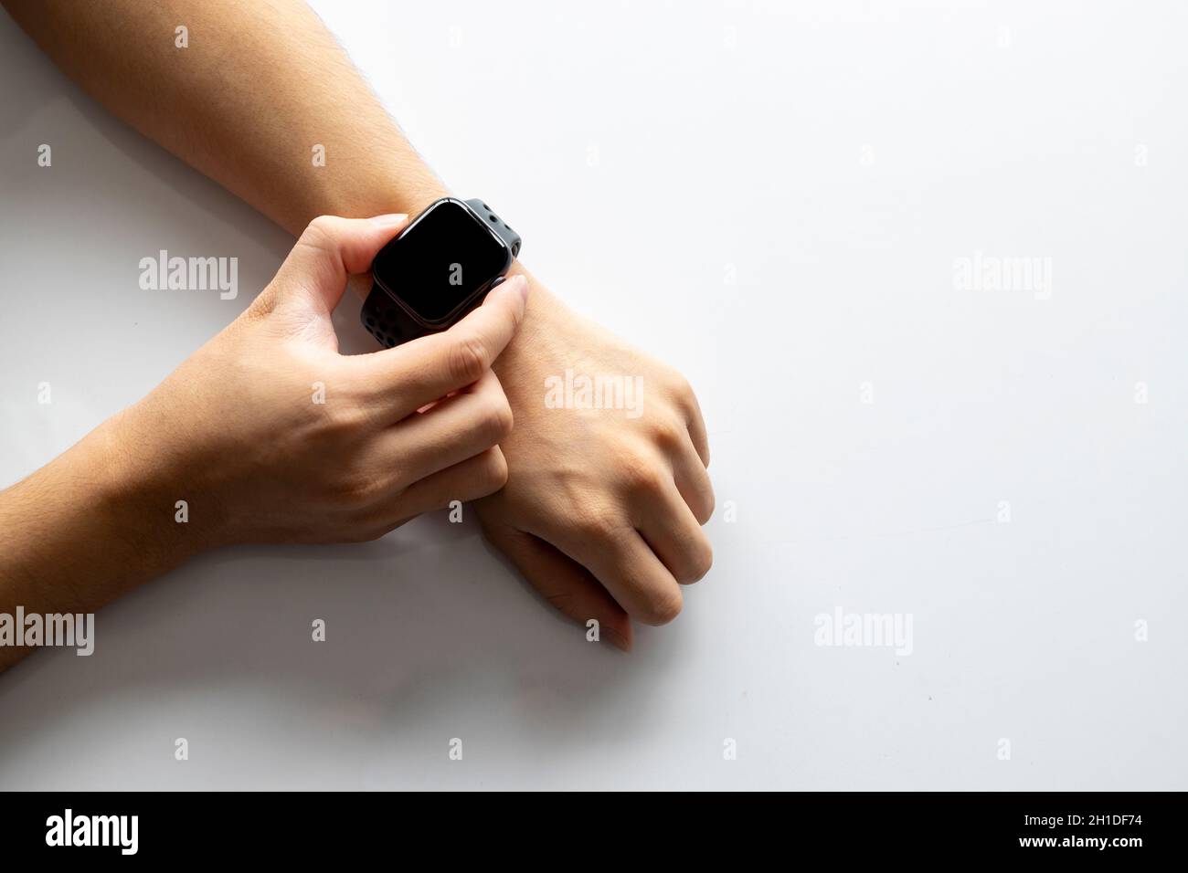 businessman wearing digital smart watch in hand touching screen to open ...