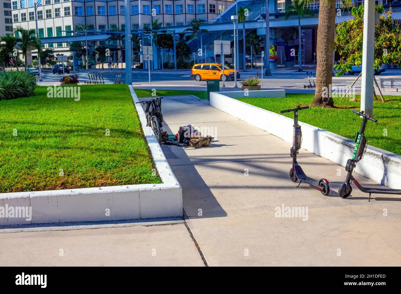 Miami, USA - November 30, 2019: Homelessness man sleep on the side walk ...