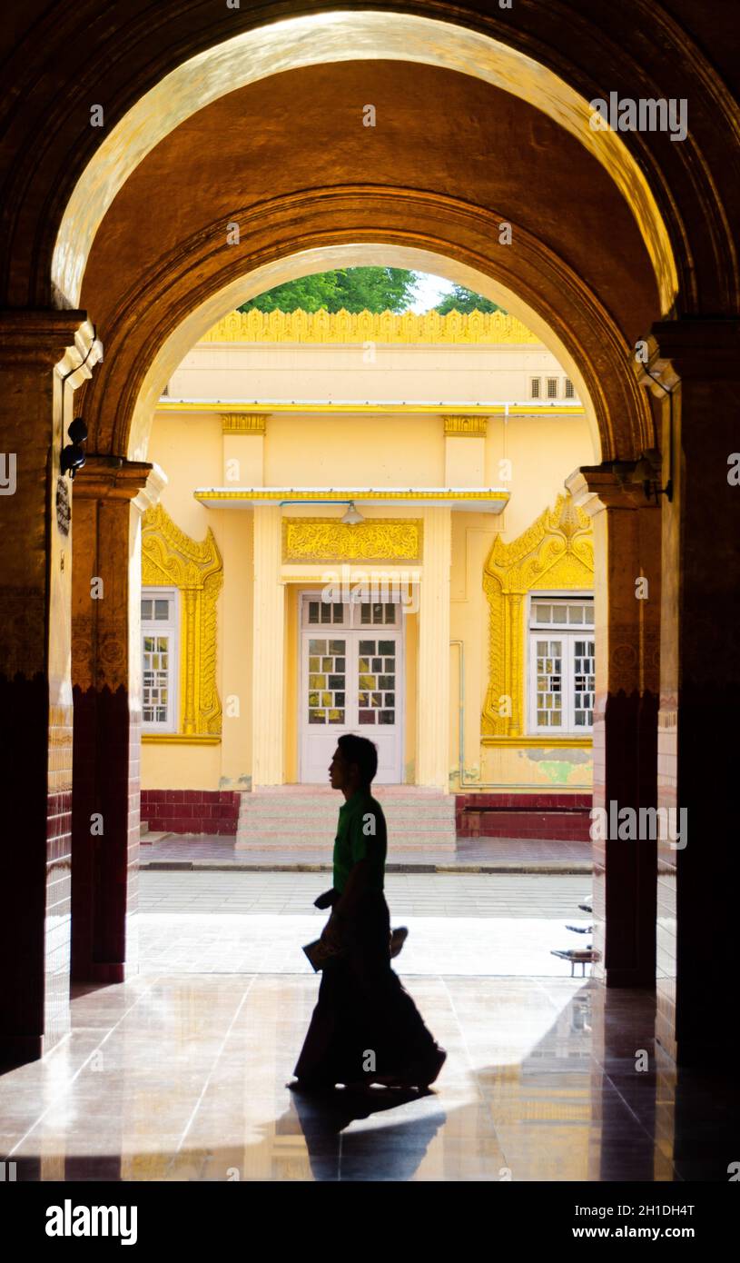 8 August 2012, Mandalay, Myanmar: Silhouette of a Burmese man wearing ...