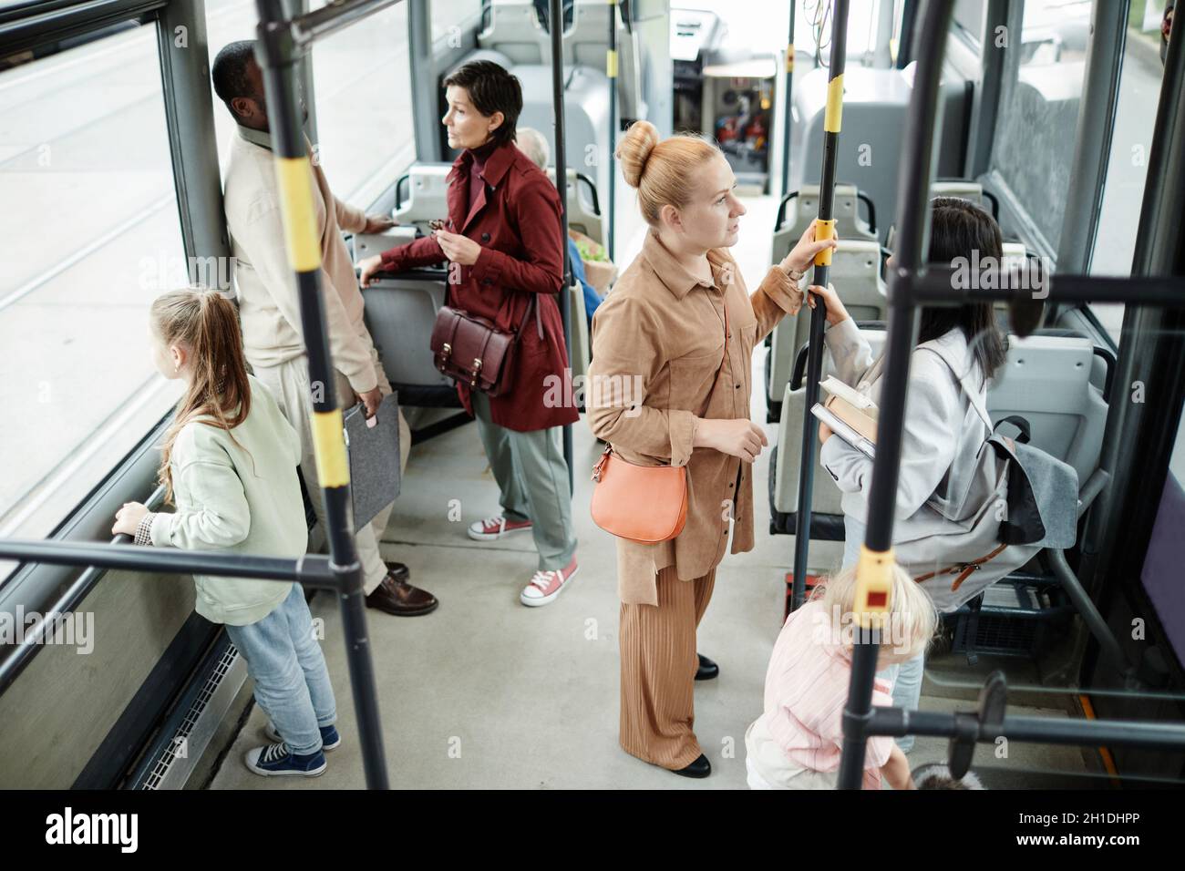 High angle view at diverse group of people in public bus, copy space ...