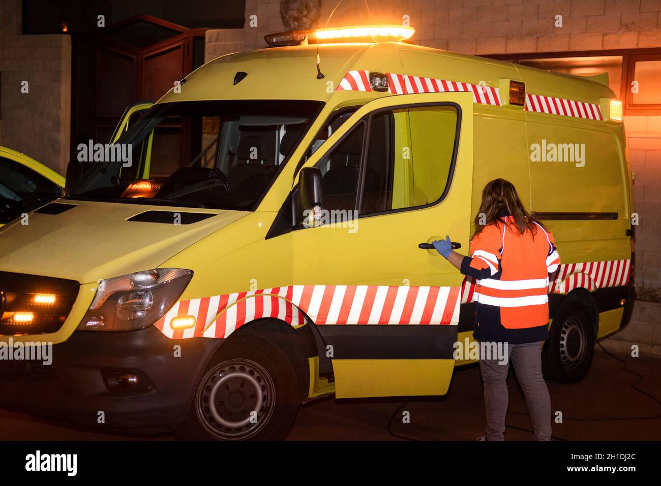 Night scene of an unrecognizable Paramedic, Ambulance woman driver at ...