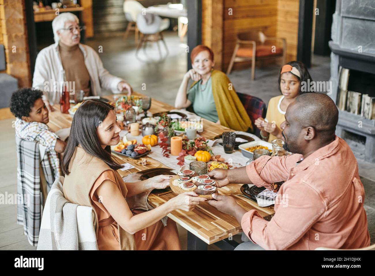 Family with children and grandparent having dinner together at the ...
