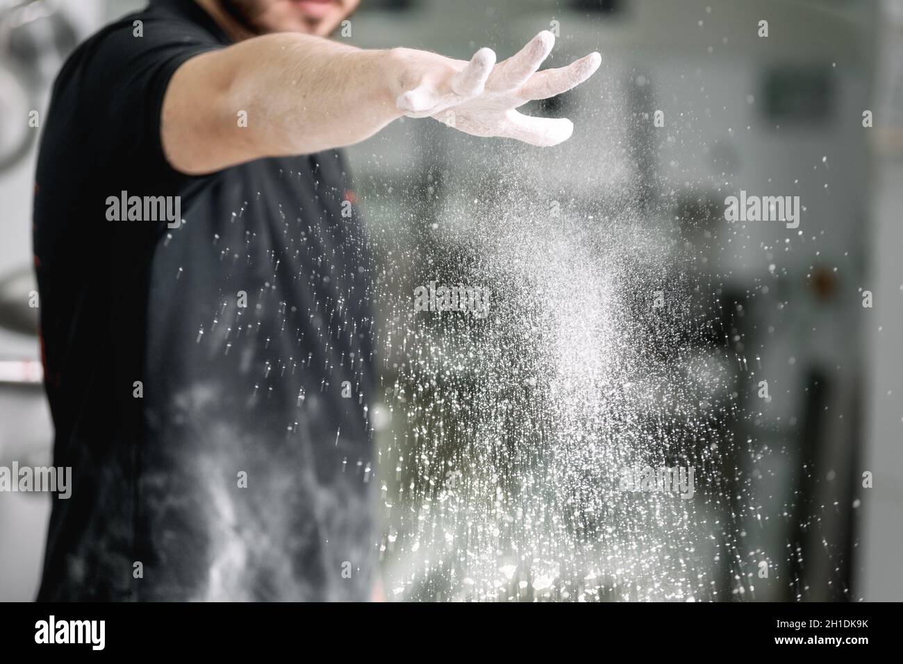 Pastry chef, pouring flour in confectionery kitchen Stock Photo - Alamy