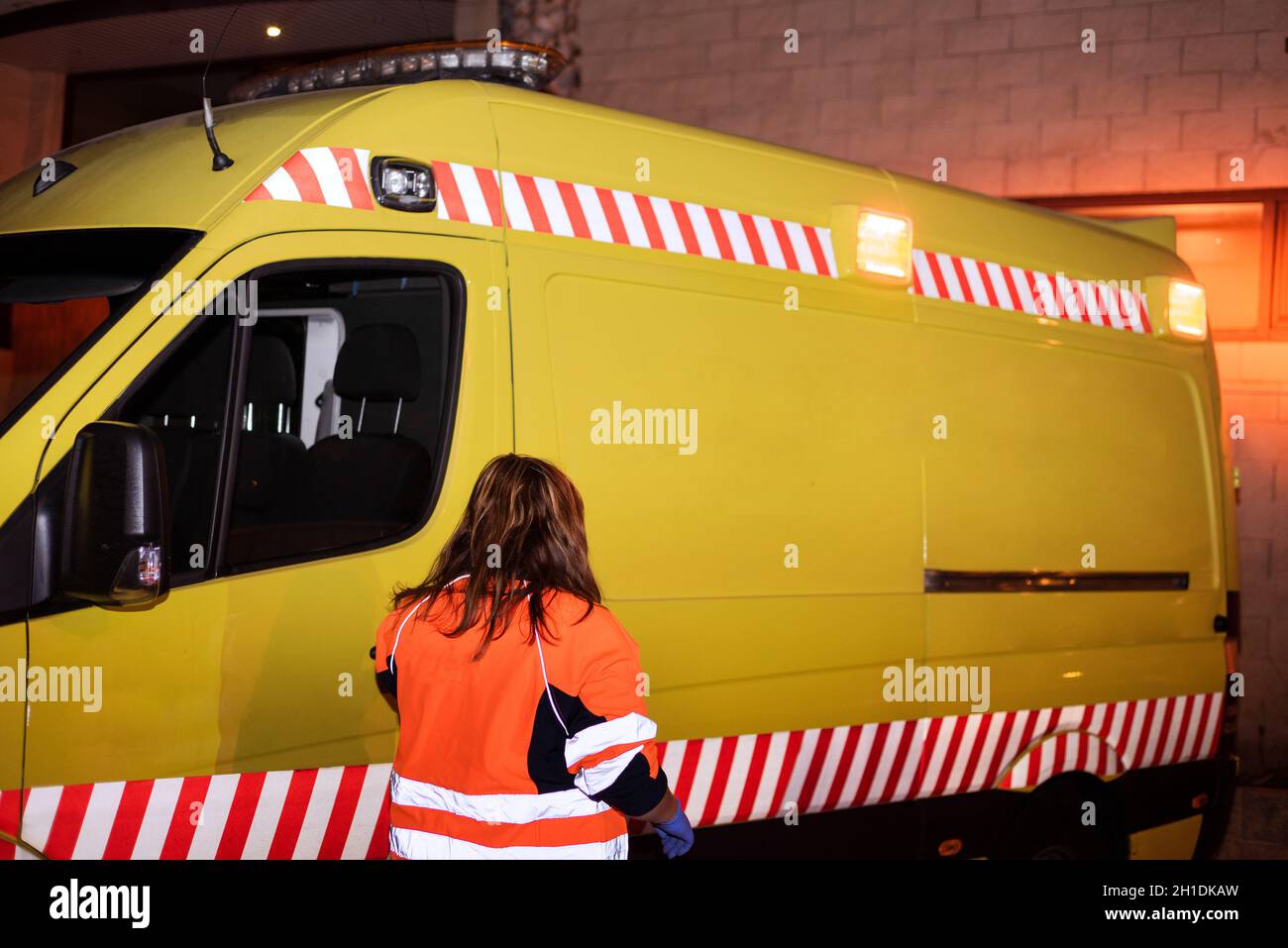 Night scene of an unrecognizable Paramedic, Ambulance woman driver at ...