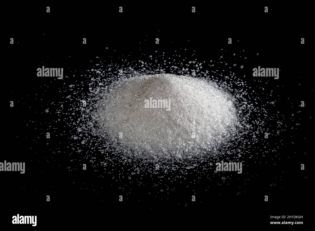 Pile of white sugar or white powder on a black surface Stock Photo - Alamy