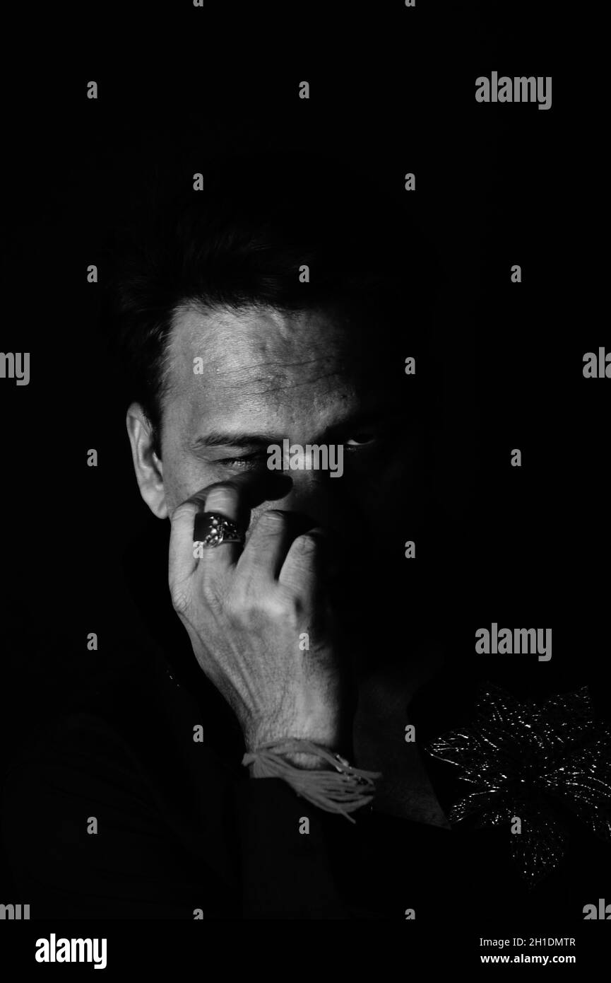 Grayscale portrait of a man in the dark room Stock Photo - Alamy