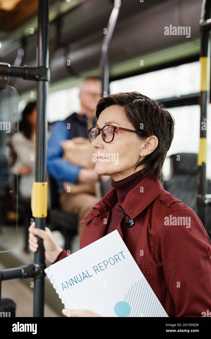 Vertical side view portrait of elegant mature woman on bus traveling by ...
