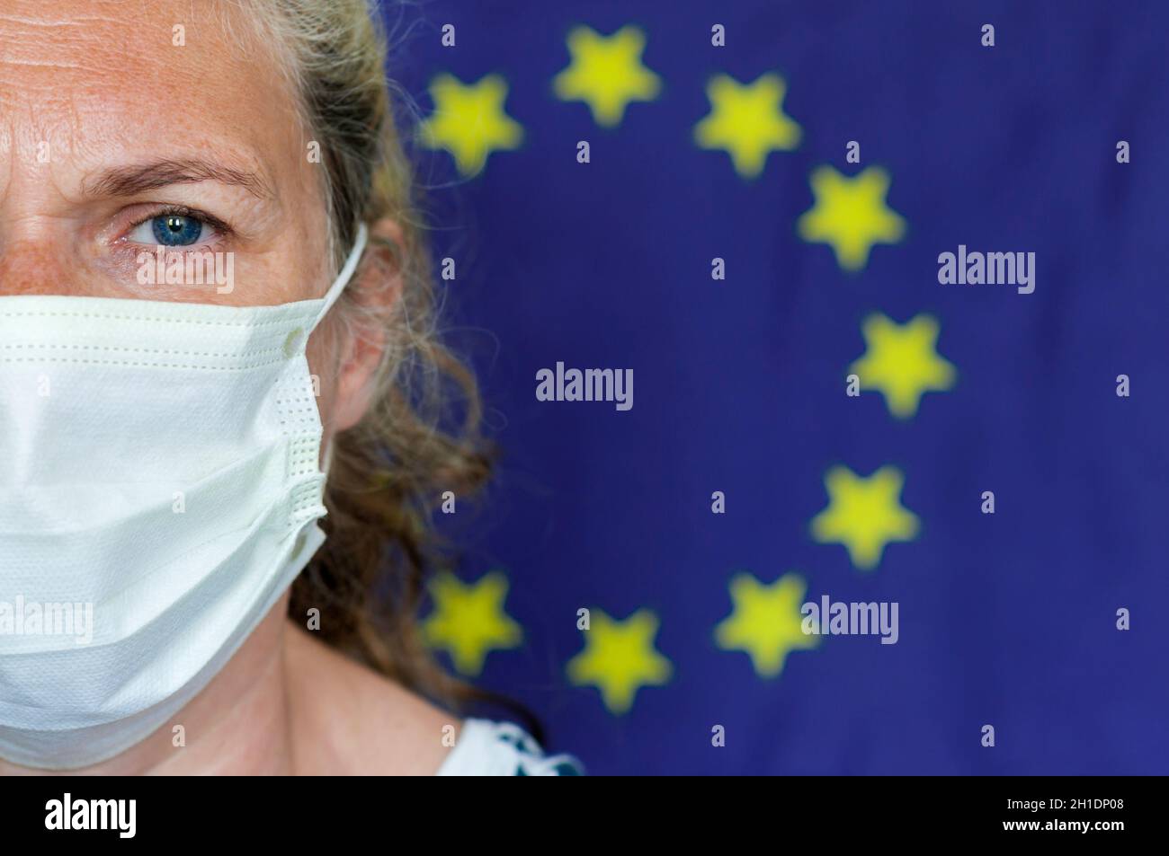 Woman with face mask in front of European Union flag, front view Stock ...