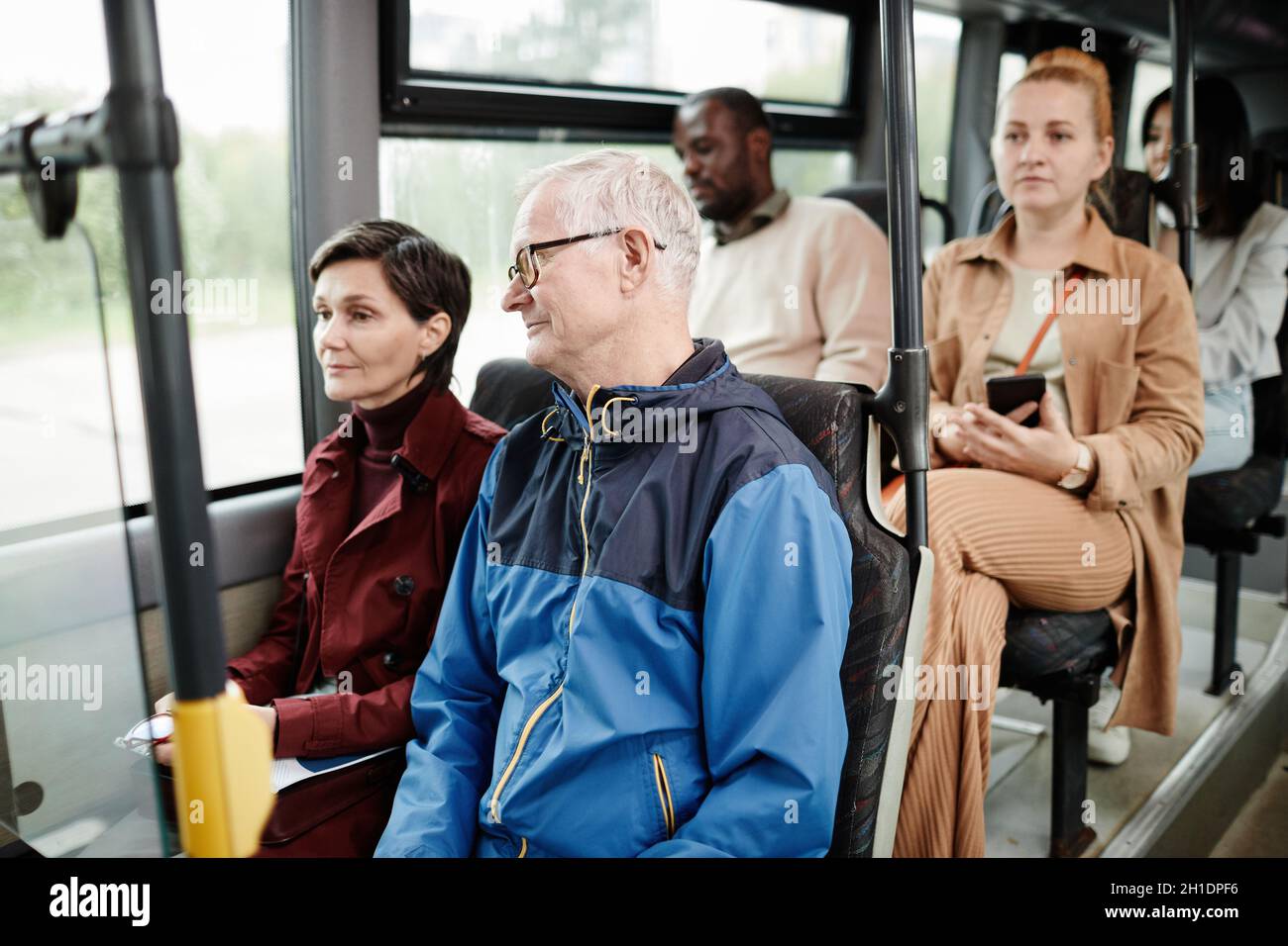 Diverse group of people on seats in public bus commuting in city Stock ...