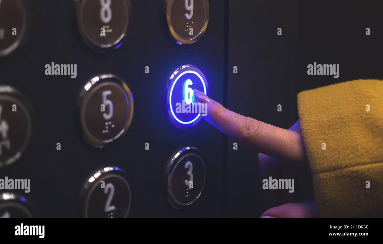 Woman hand pushing elevator button closeup view with led lights. Hand ...