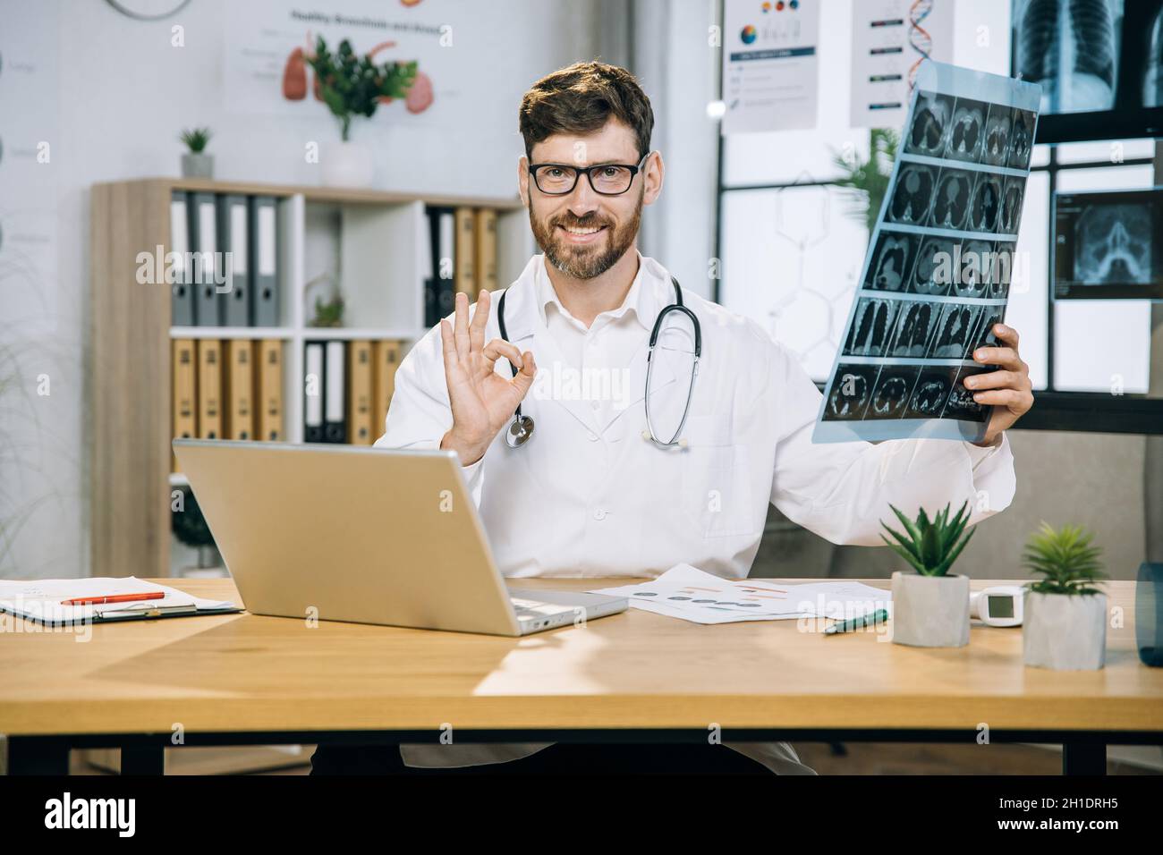 Yes, I did it. Likable smiling male doctor scientist, showing okay sign ...