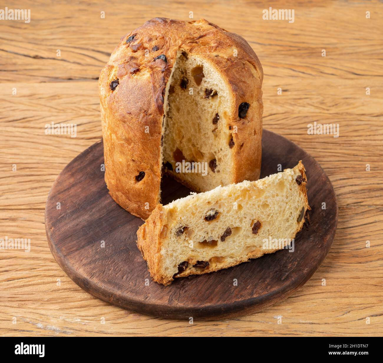 Traditional italian christmas fruit cake panettone with slice on a ...