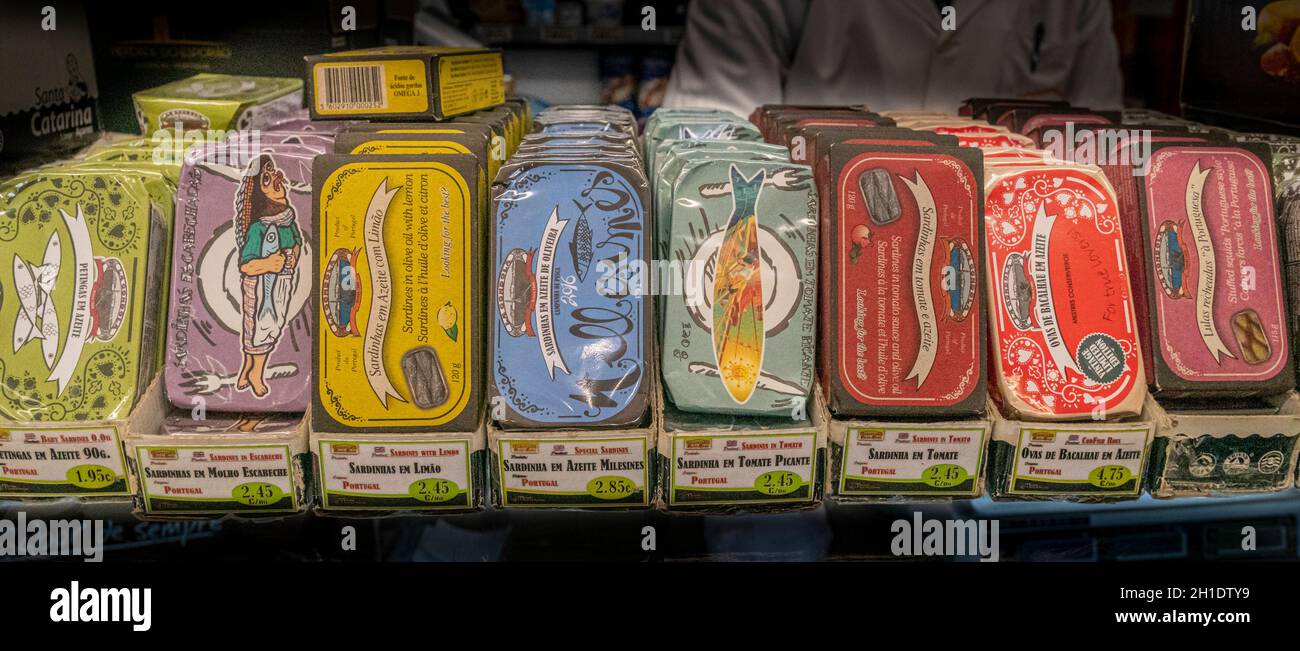 A row of various sardine tins for sale on a market stall Stock Photo ...