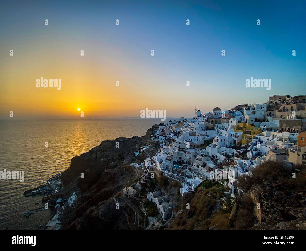 panoramic view of Oia village with traditional white architecture and ...