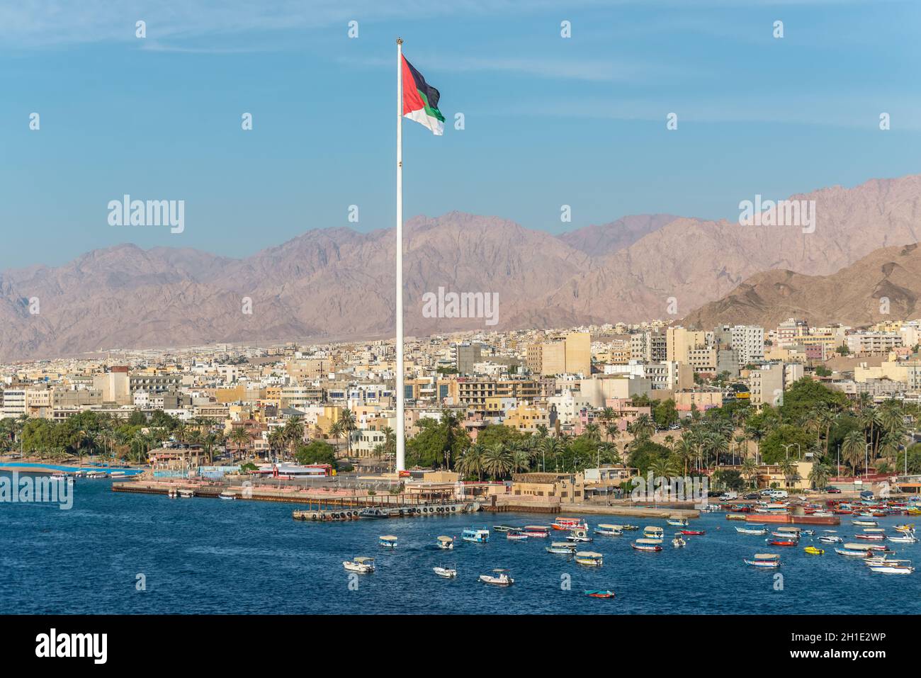 Aqaba, Jordan - November 6, 2017: Cityscape of Aqaba and flag of Jordan ...