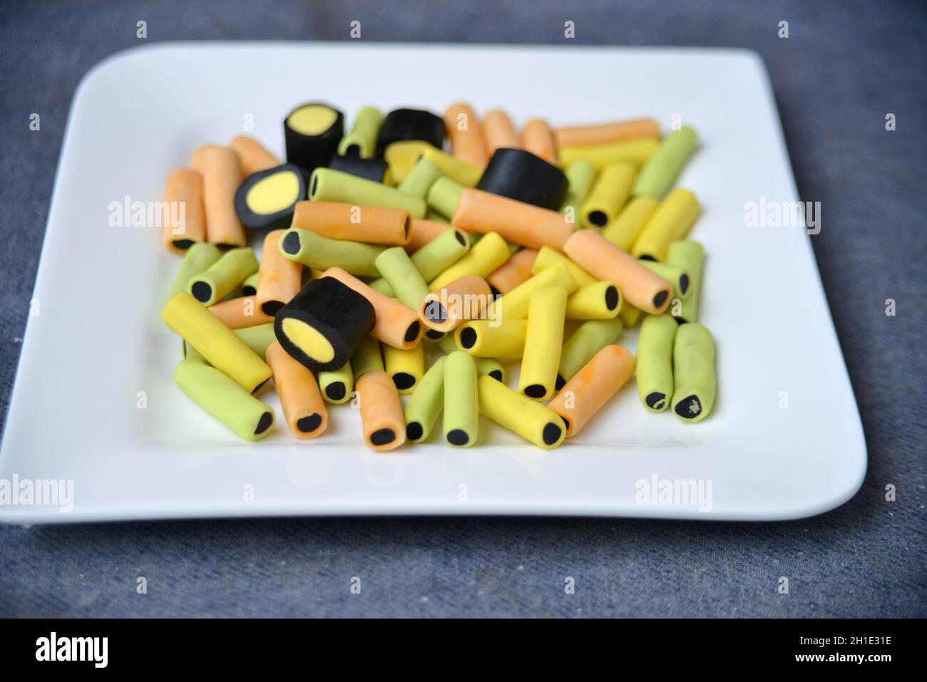 Colorful licorice candies on white plate Stock Photo - Alamy