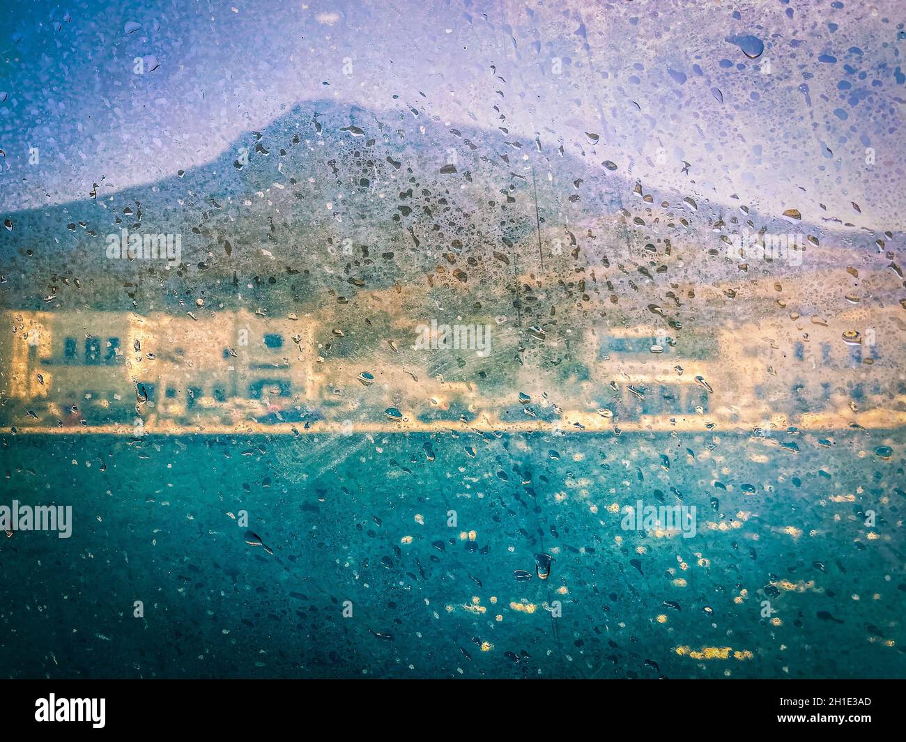 Melancholy coastal view seen through a window boat, Greece island ...
