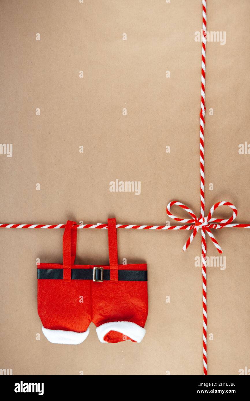 Christmas string or twine tied in a bow on craft paper and Santa Claus ...