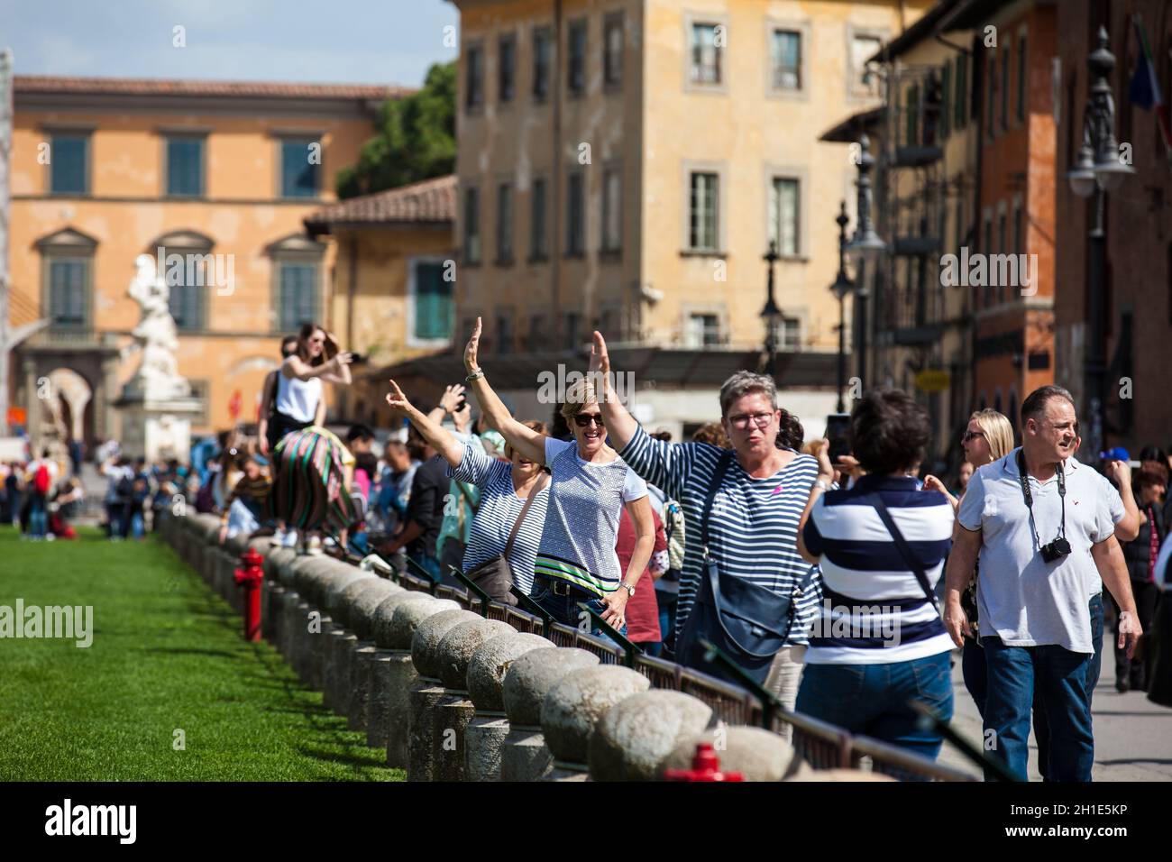 PISA, ITALY - APRIL, 2018: Tourists posing and taking pictures in front ...