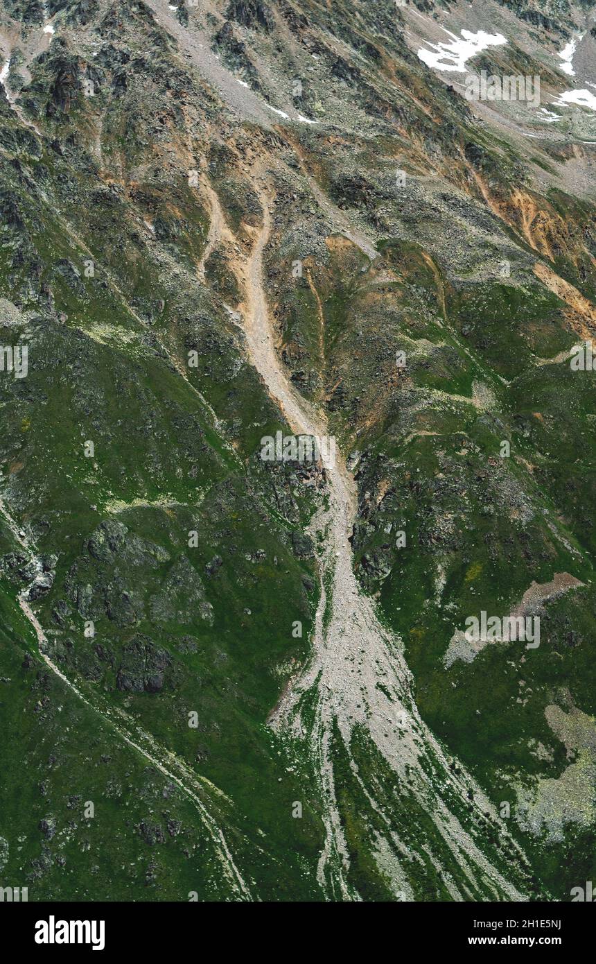 The texture of the mountain. The relief of a mountain slope with snow ...