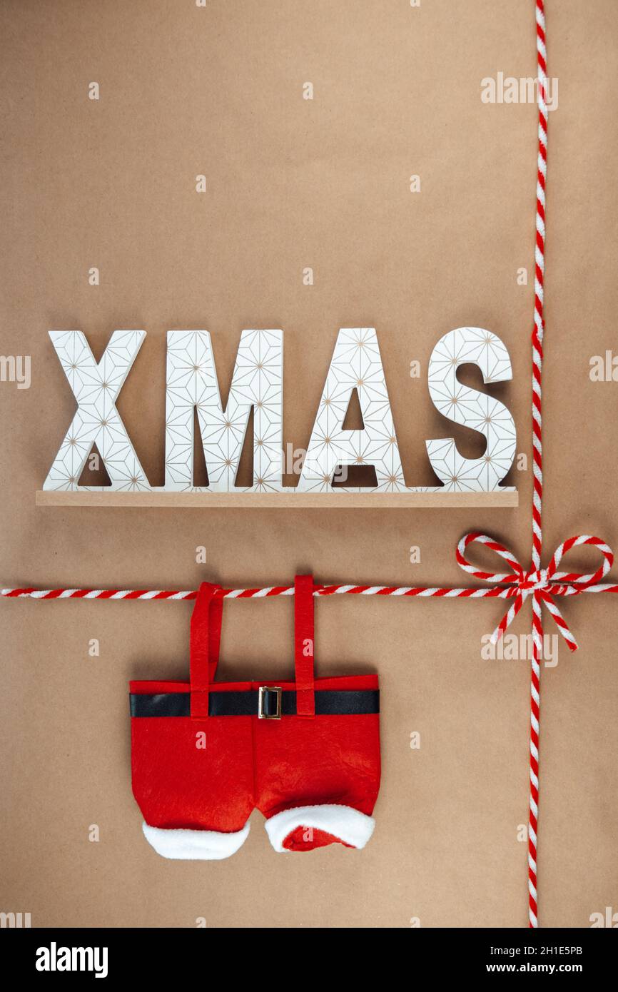 Christmas string or twine tied in a bow on craft paper with Xmas sign ...