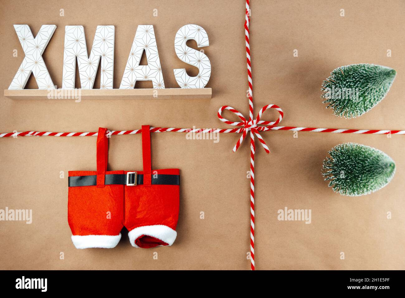Christmas string or twine tied in a bow on craft paper with Xmas sign ...