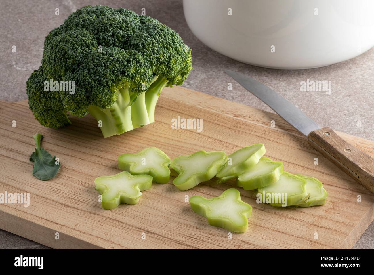 Fresh raw broccoli and a chopped stem on a cutting board Stock Photo ...