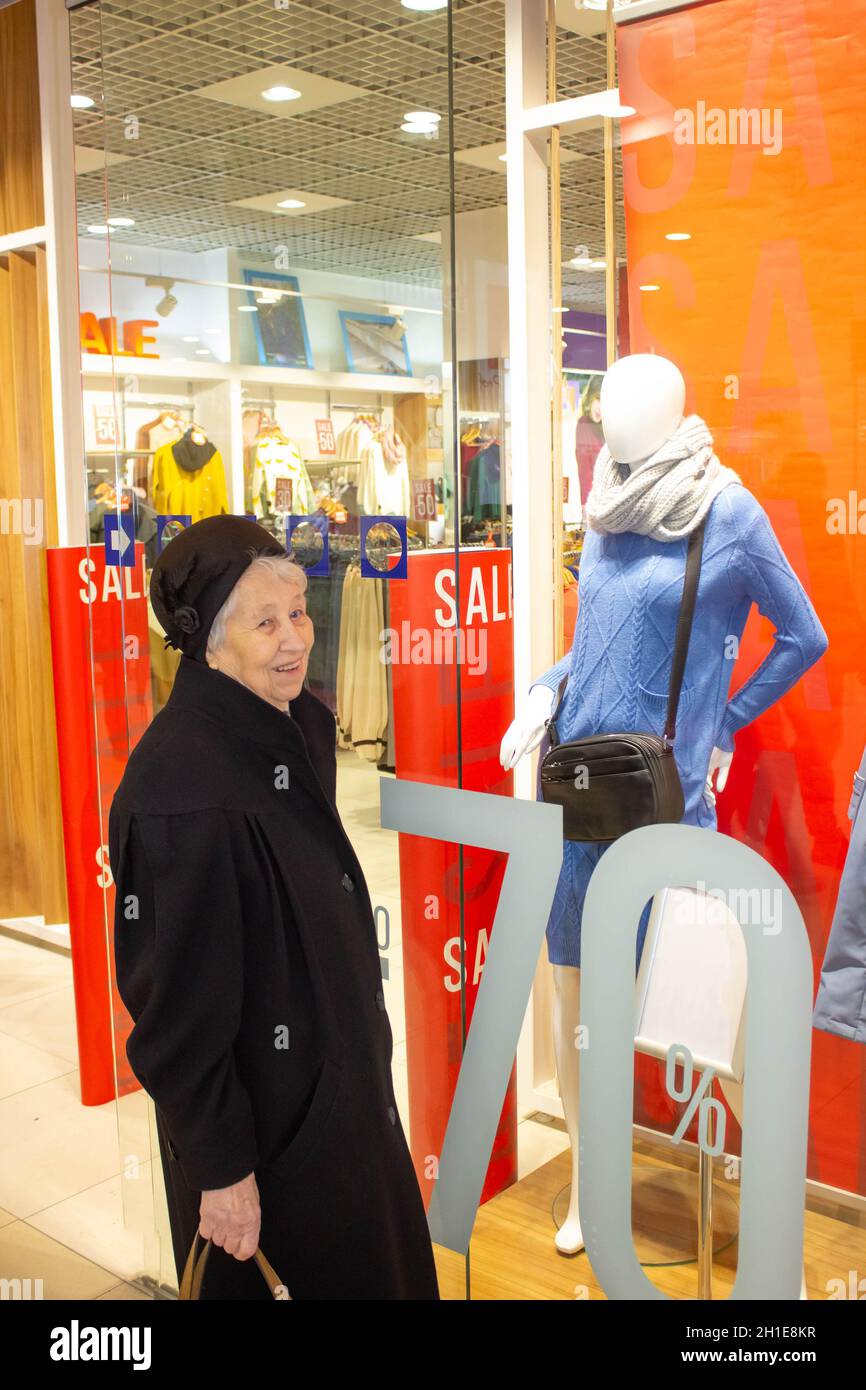 Senior old woman looking at clothes at shopping mall Stock Photo - Alamy