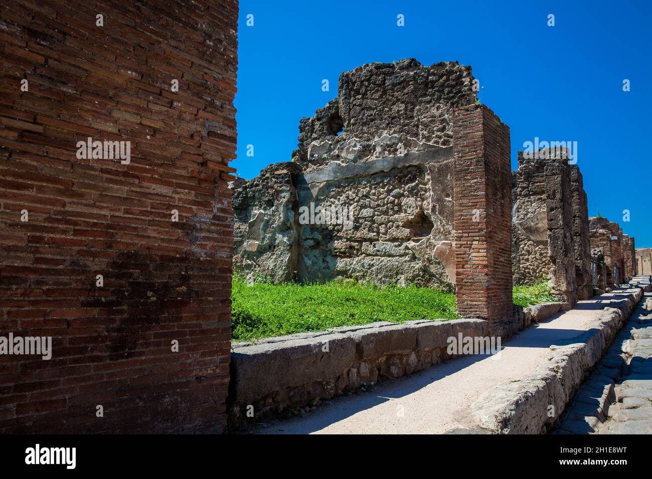 The streets of Pompeii made of large blocks of black volcanic rocks ...
