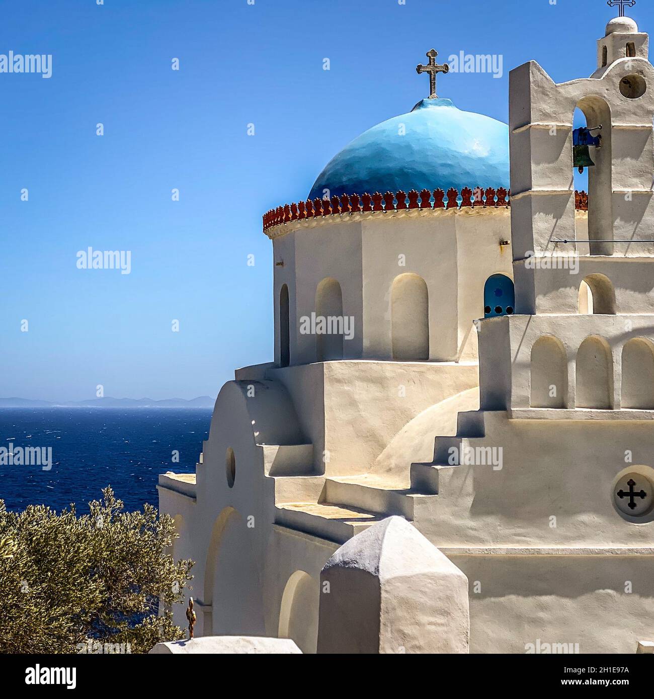 Traditional bells tower and blue dome of the orthodox white churches ...