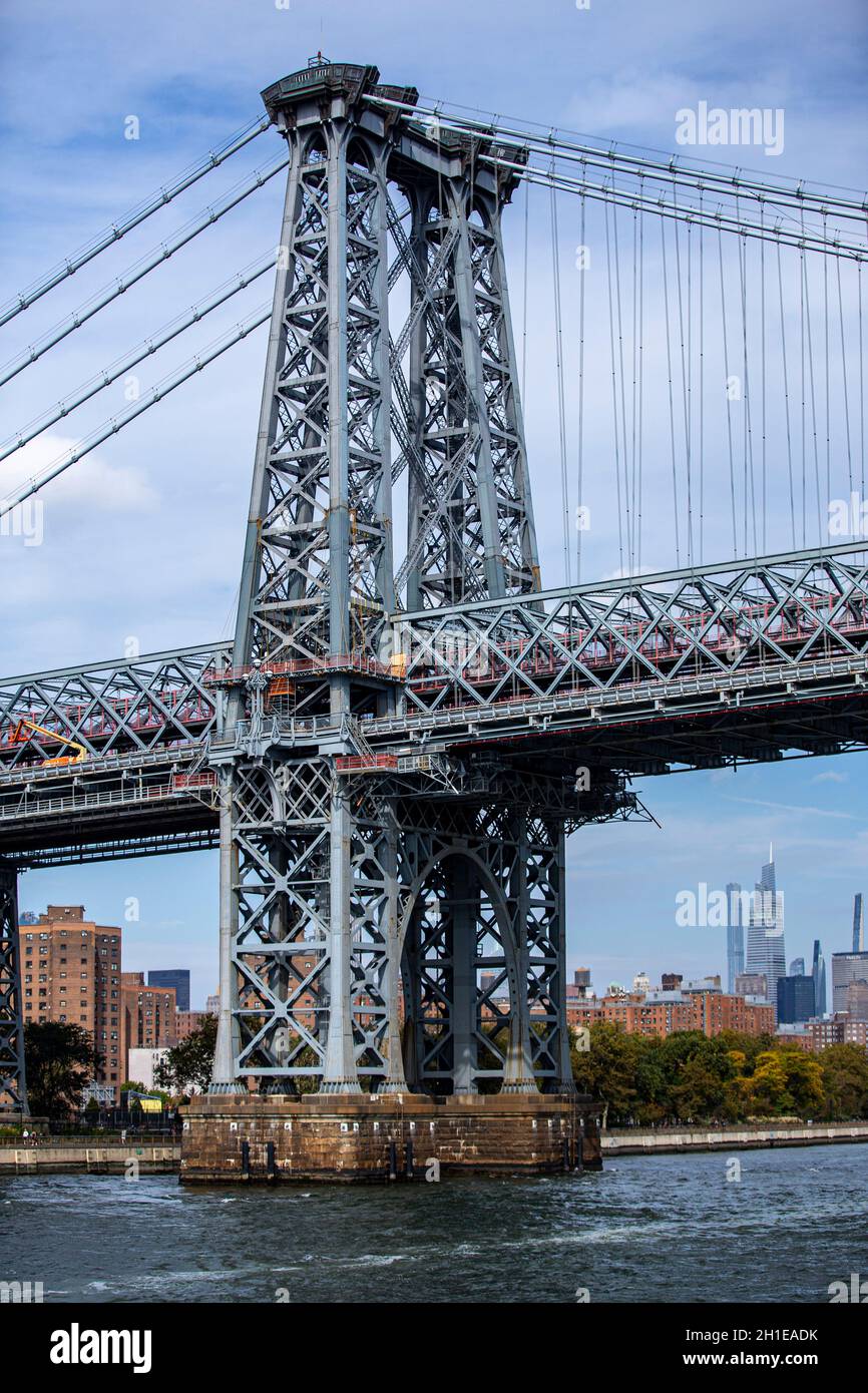 A view of Williamsburg Bridge from the East River in New York City ...