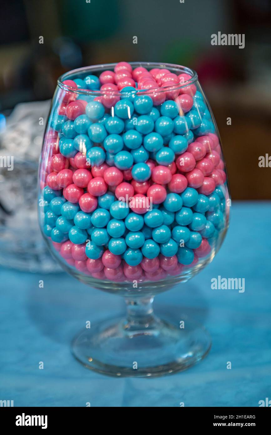 Pink and blue candies in a glass goblet at a gender reveal party Stock ...
