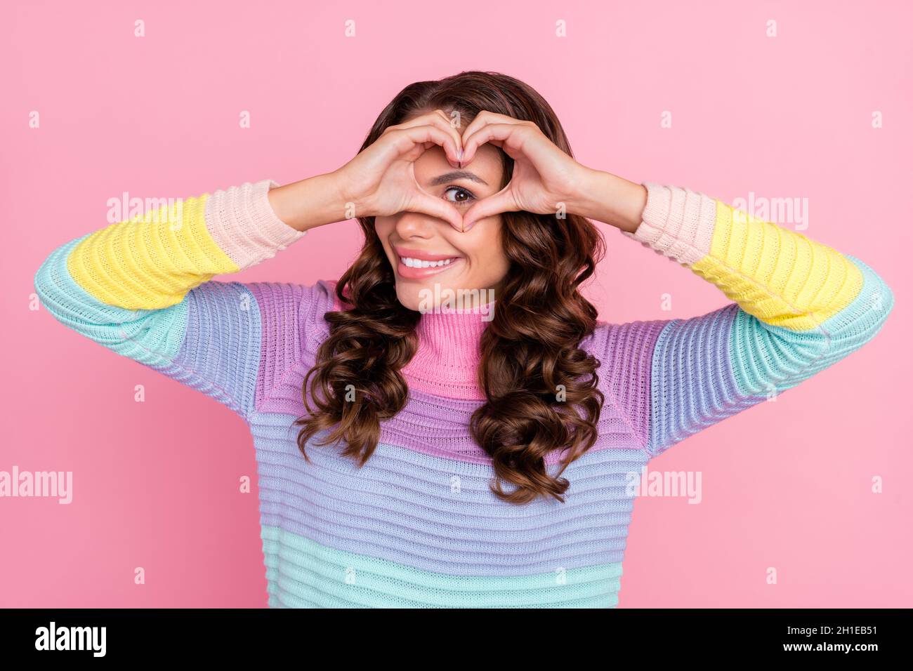 Photo of young funny girl show hands heart figure look watch eye ...