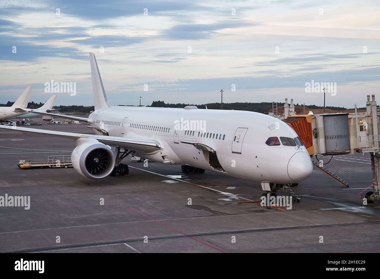 Airplane parked at an airport for boarding Stock Photo - Alamy