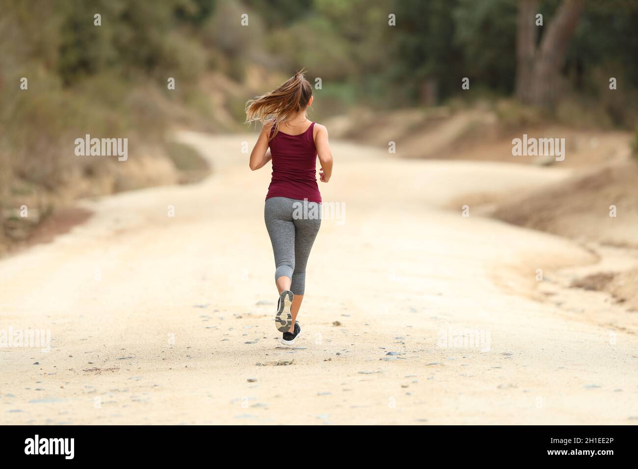 Back view of a runner running alone in the mountain Stock Photo - Alamy