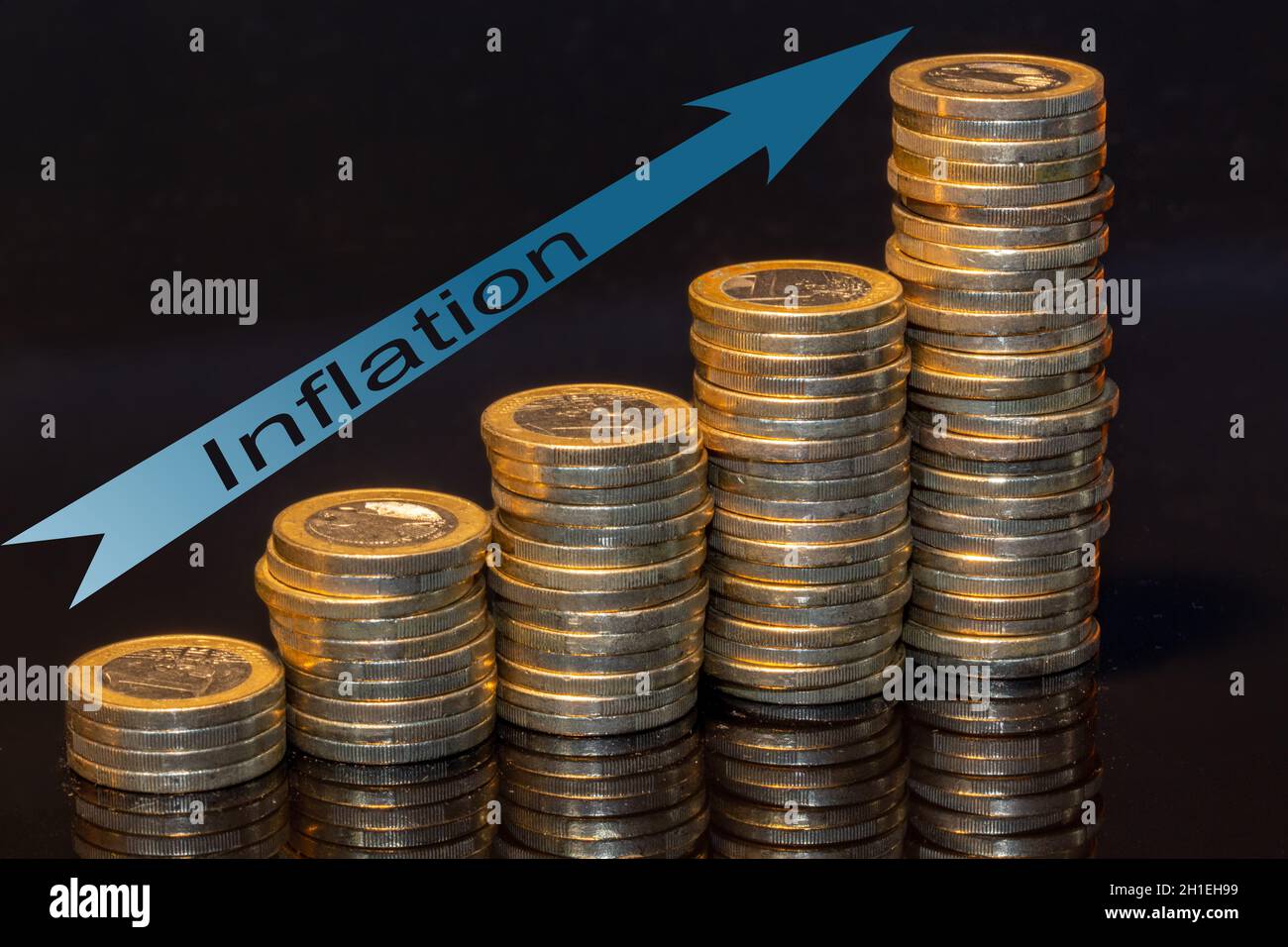 Symbolic image inflation: Stacked one-euro coins with an arrow with the ...