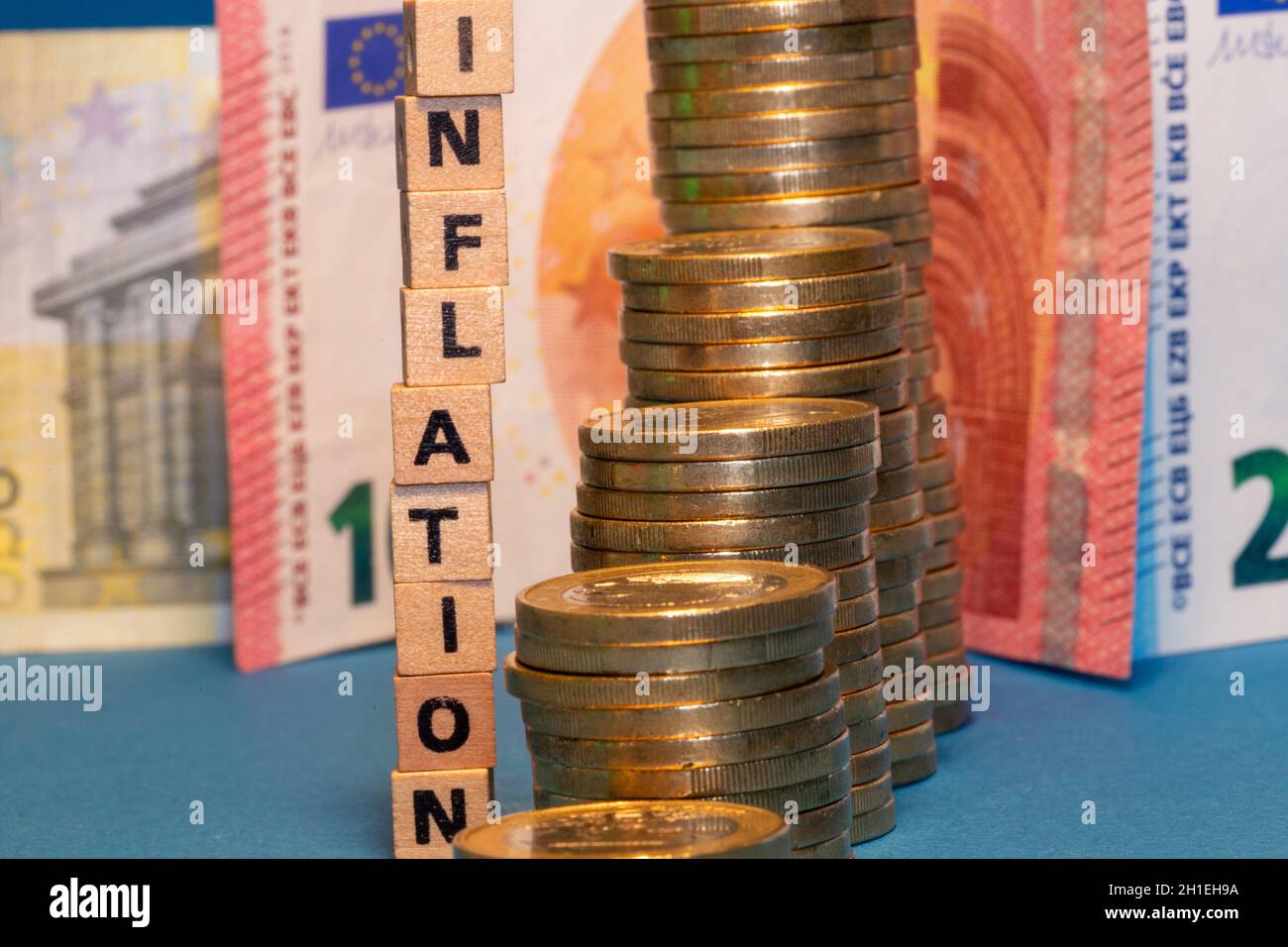 Symbolic image inflation: Stacked one-euro coins with letter cubes ...