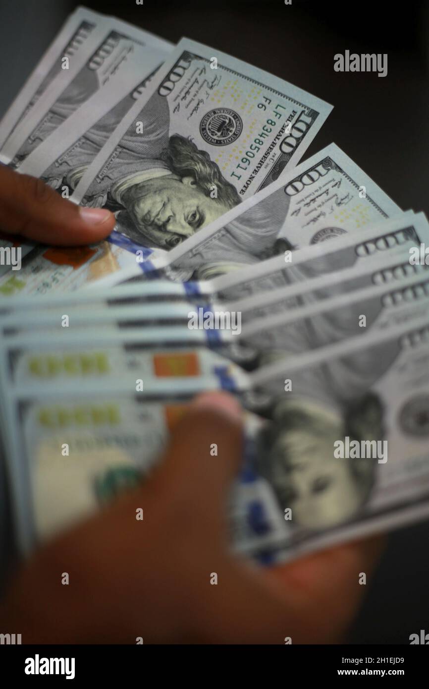 salvador, bahia / brazil - february 11, 2015: Hands hold dollar ...
