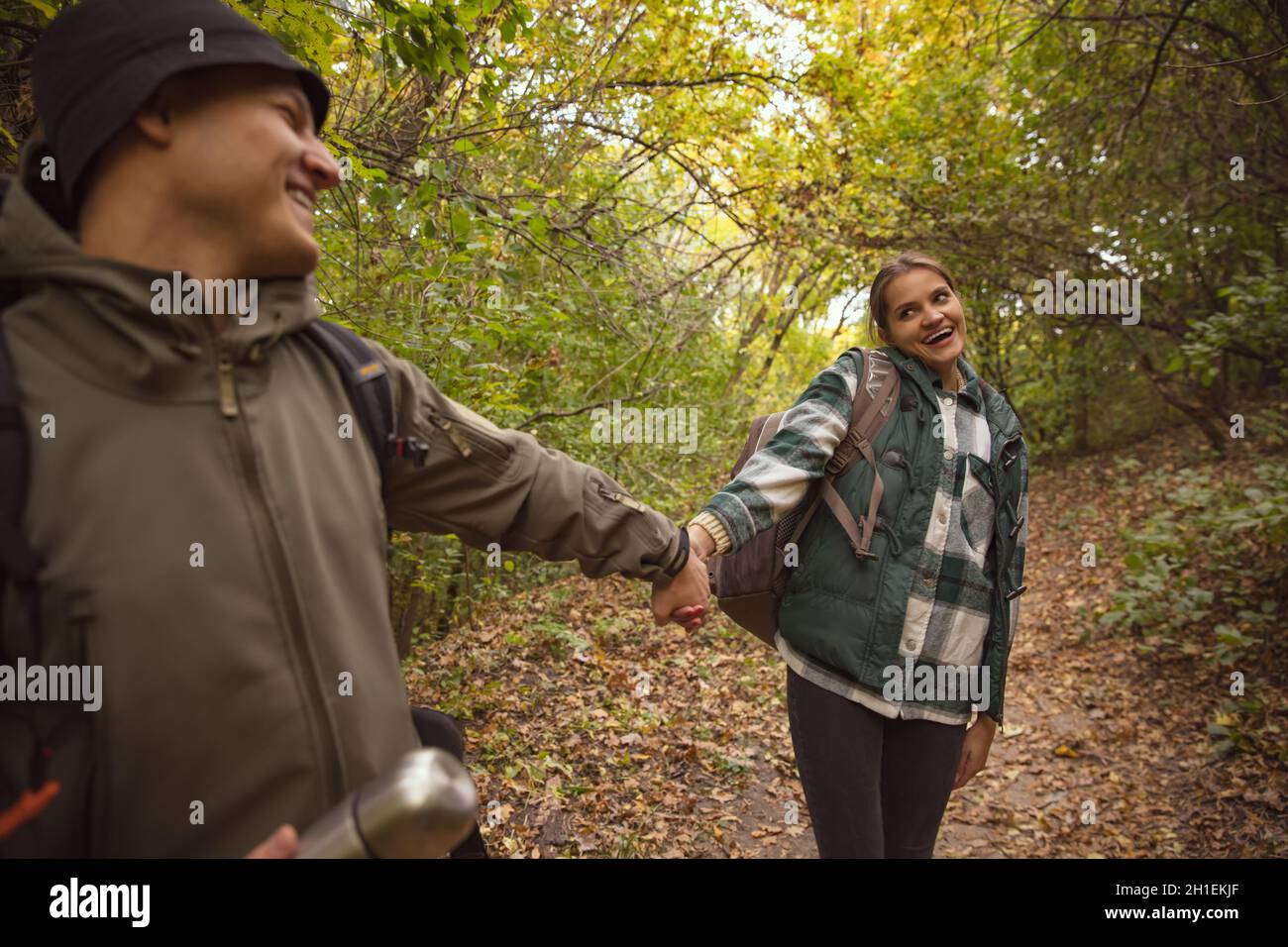 Cropped portrait of happy, joyful couple holding hands, spending time ...